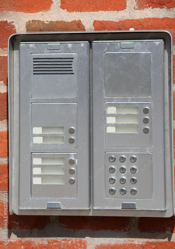 modern intercom with various bell buttons and a numeric keypad to dial ...