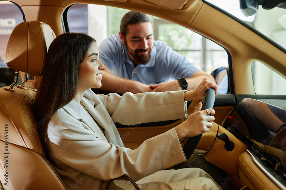Side view of happy woman behind wheel of vehicle with beige leather ...