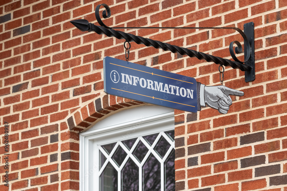 The exterior of a red and brown brick building with a white overhang ...