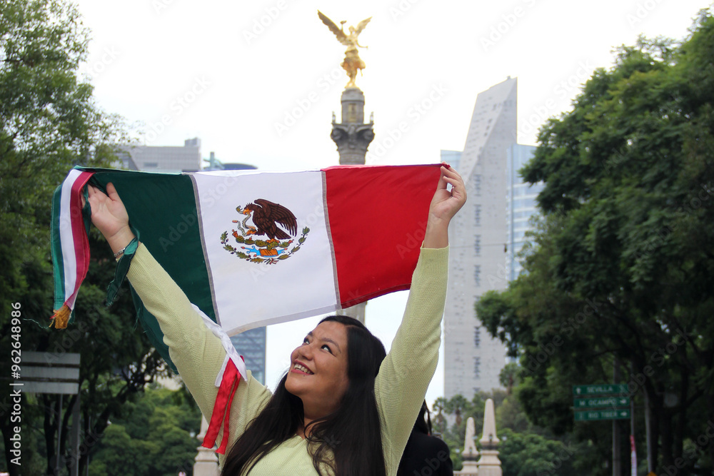 40 year old Latina woman proudly displays the Mexican flag on the ...