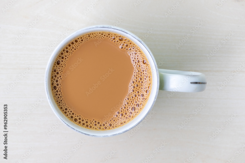 Poster A cup of milk tea or dudh cha in a ceramic cup on light wooden ...