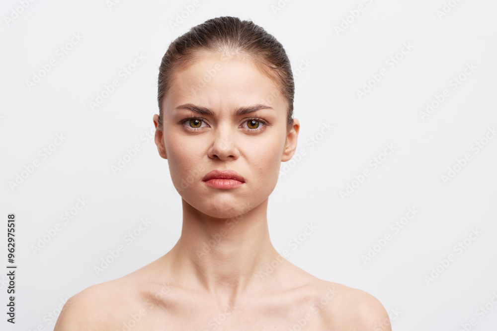 Serious expression, female portrait, neutral background, intense look ...