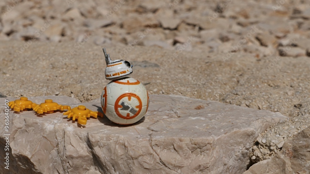 Model of Star Wars spherical astromech droid BB8 followed by yellow ...