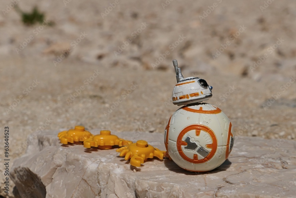 Model of Star Wars spherical astromech droid BB8 chased by yellow LEGO ...