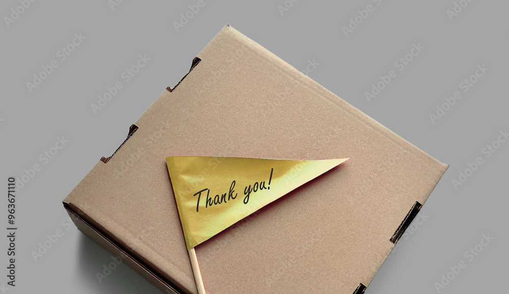 'Thank you' note day. Closed square cardboard box with tiny golden ...