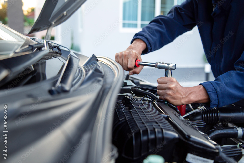 Professional mechanic working on the engine , repairing a car engine ...