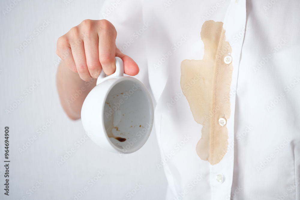 A person holding an empty white coffee cup in their right hand. The cup ...