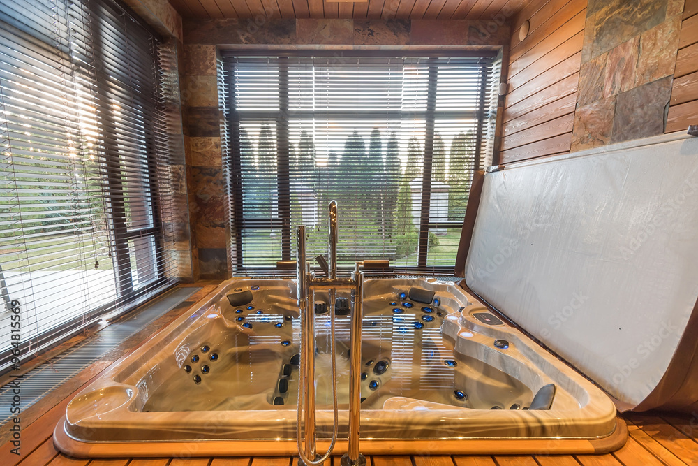 Exclusive modern Jacuzzi on the glazed terrace of a luxury mansion ...