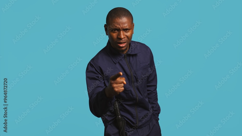 Security guard pointing finger, scolding people for trespassing on ...