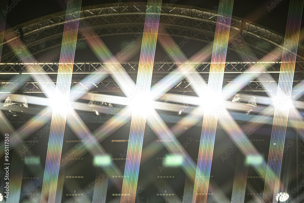 A powerful display of bright stage lights creates a vibrant starburst ...