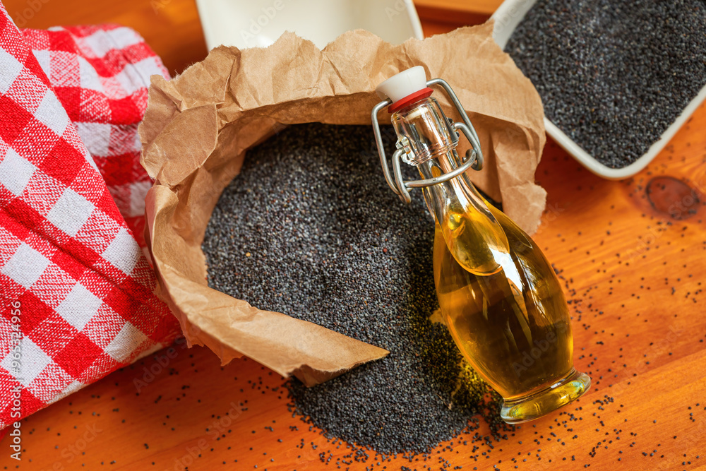 Edible poppy seed oil or poppyseed oil with some dry Opium poppy seeds ...