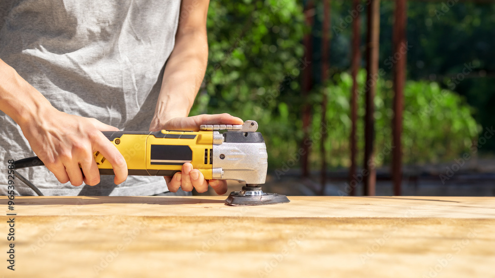 Unrecognized Female Carpenter Is Sanding A Piece Of Wood With An ...