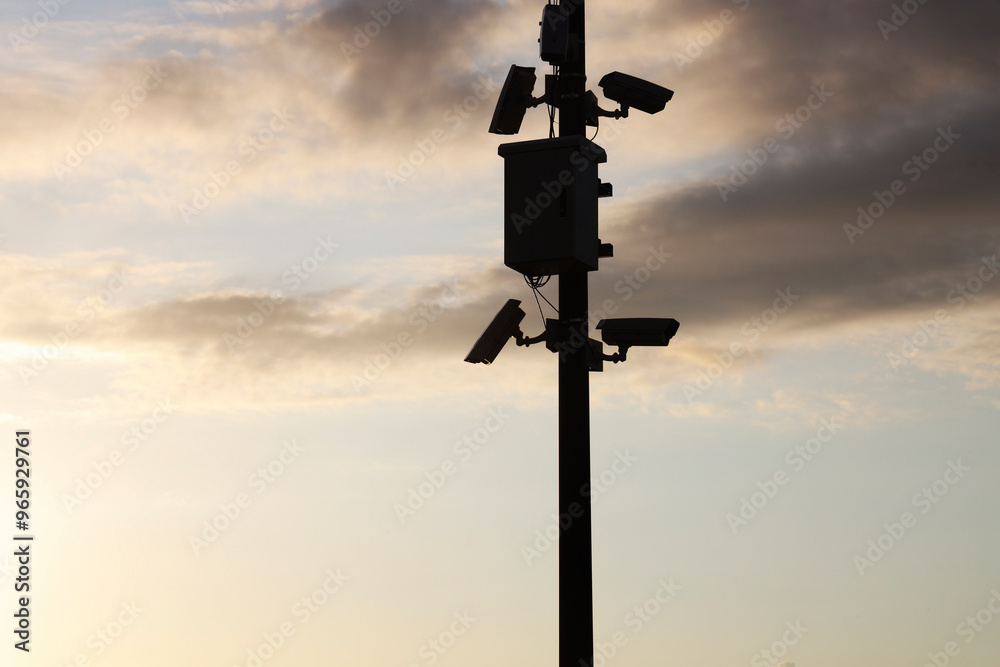 black silhouette of many, a lot CCTV street cameras on pole on dark ...