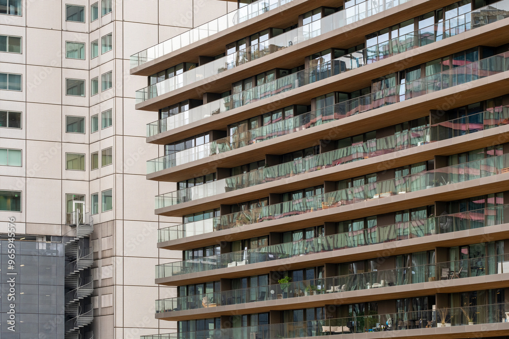 The photo captures a modern apartment complex with multiple floors ...
