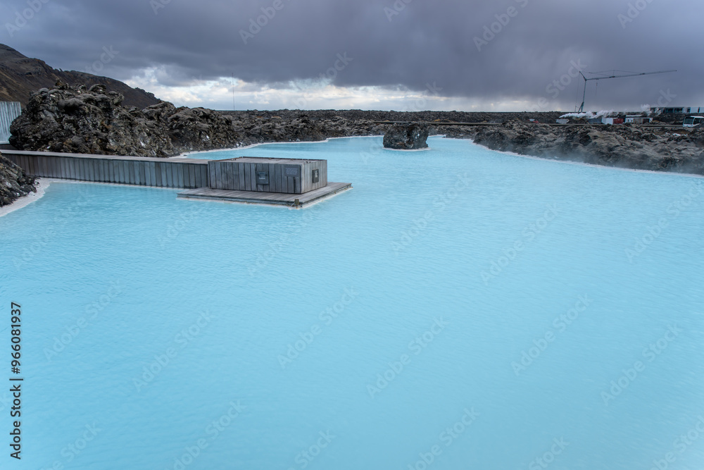 Milky blue waters of the Blue Lagoon in Iceland contrast with black ...