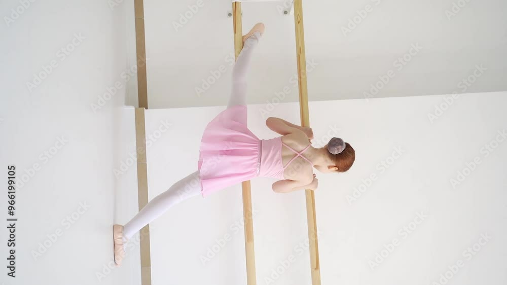 Young ballet girl at studio lesson. Training performance. Stretching ...