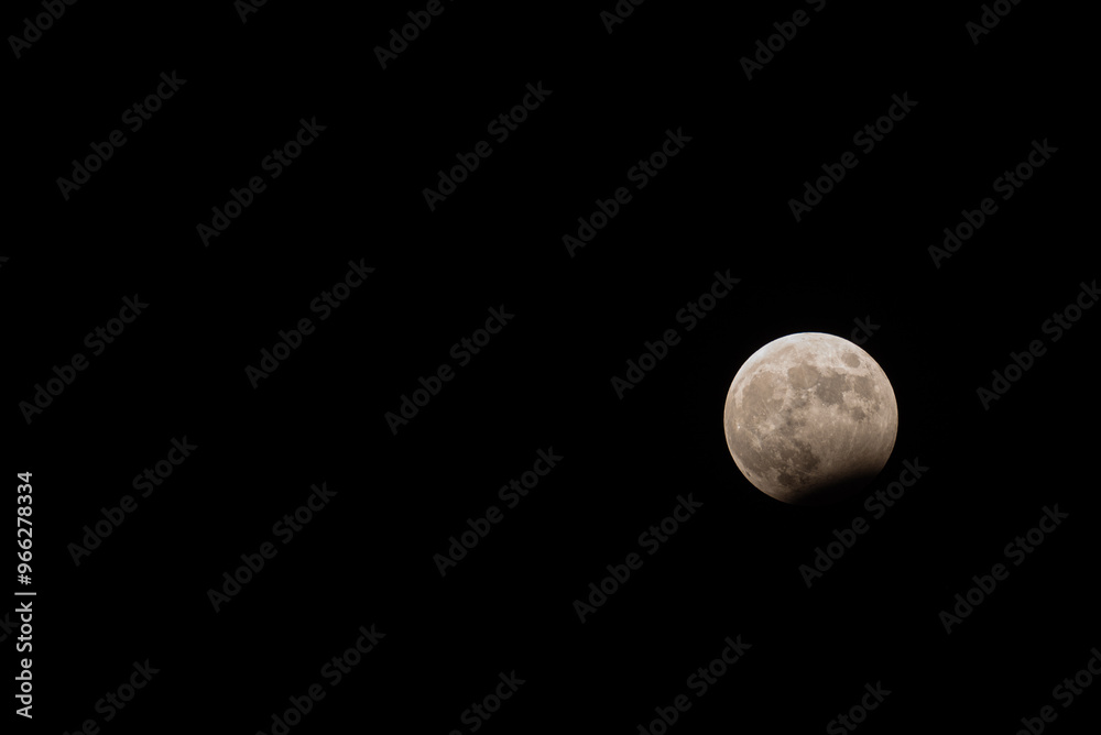 Lunar eclipse, full moon with a hidden part. Negative space and void ...