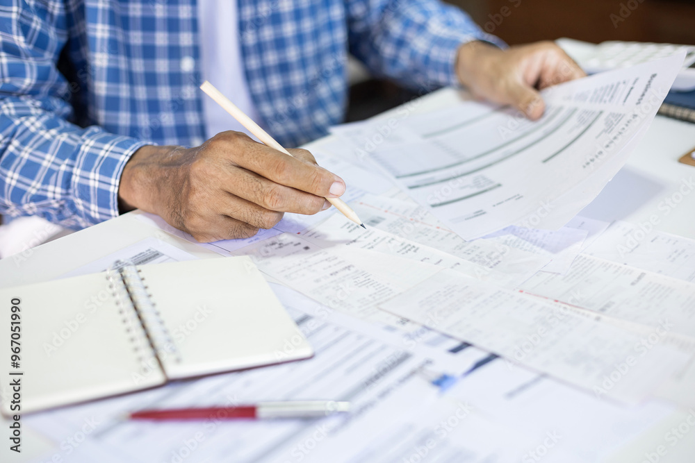 Asian man hands holding pencil checking income and expenses from ...