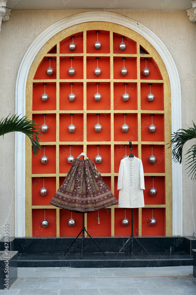 The image features a decorative display with traditional wedding attire ...