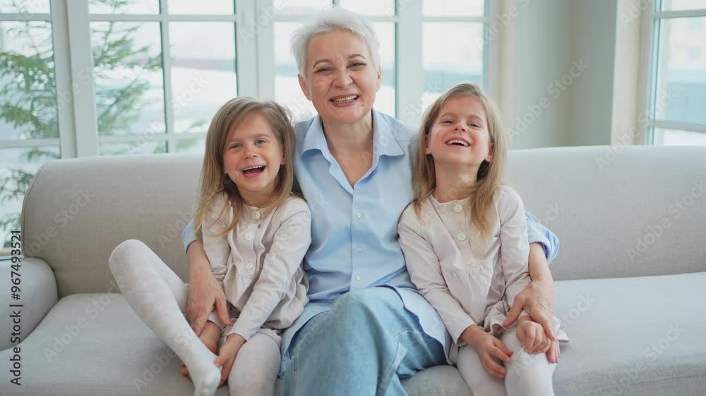 Happy family at home. Two little girls sisters twins grandmother ...
