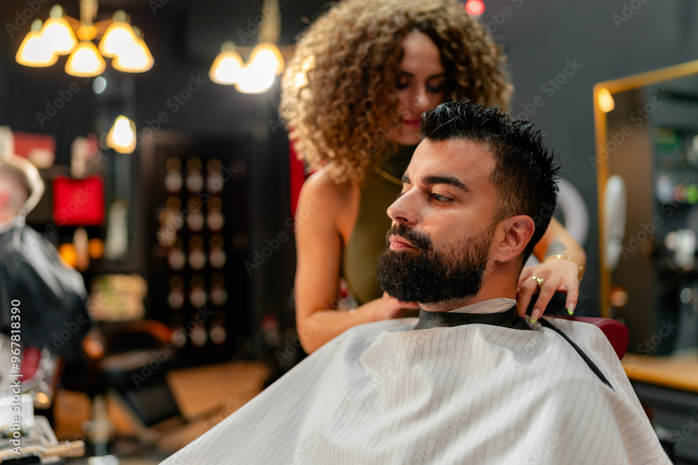 Expert barber meticulously trims and styles a man's hair using scissors ...