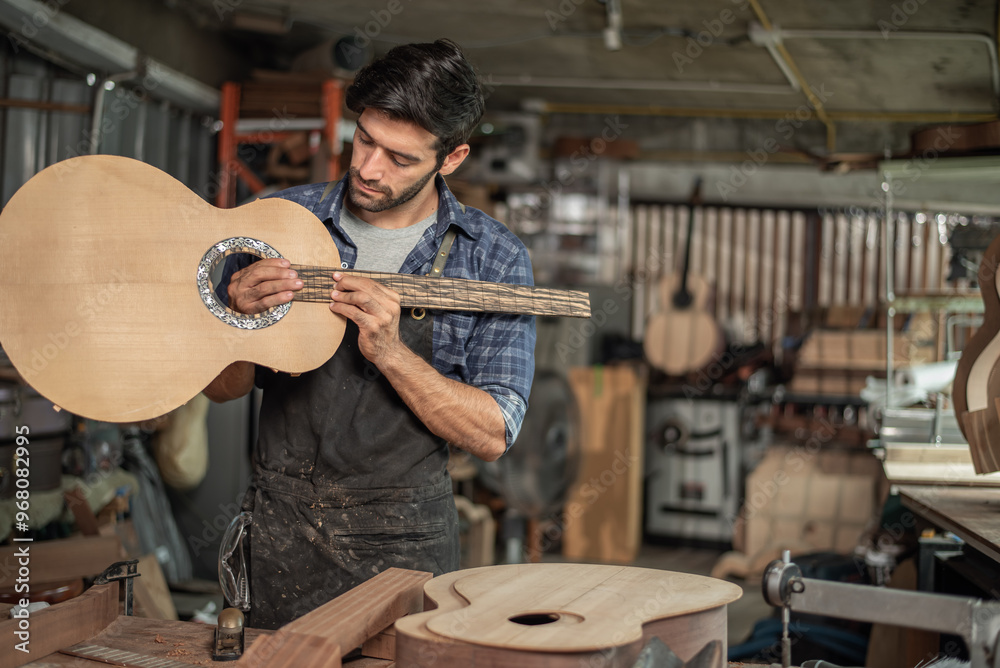 Luthier creating a guitar and using tools in a traditional Stock Photo ...