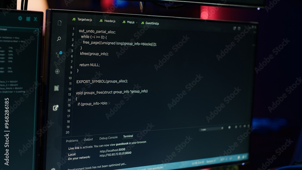 Extreme close up of software interface on PC screens showing lines of code running in empty ...