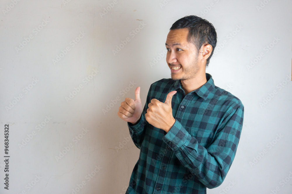 Young Adult Asian men pointing finger to the left with smiling face and ...
