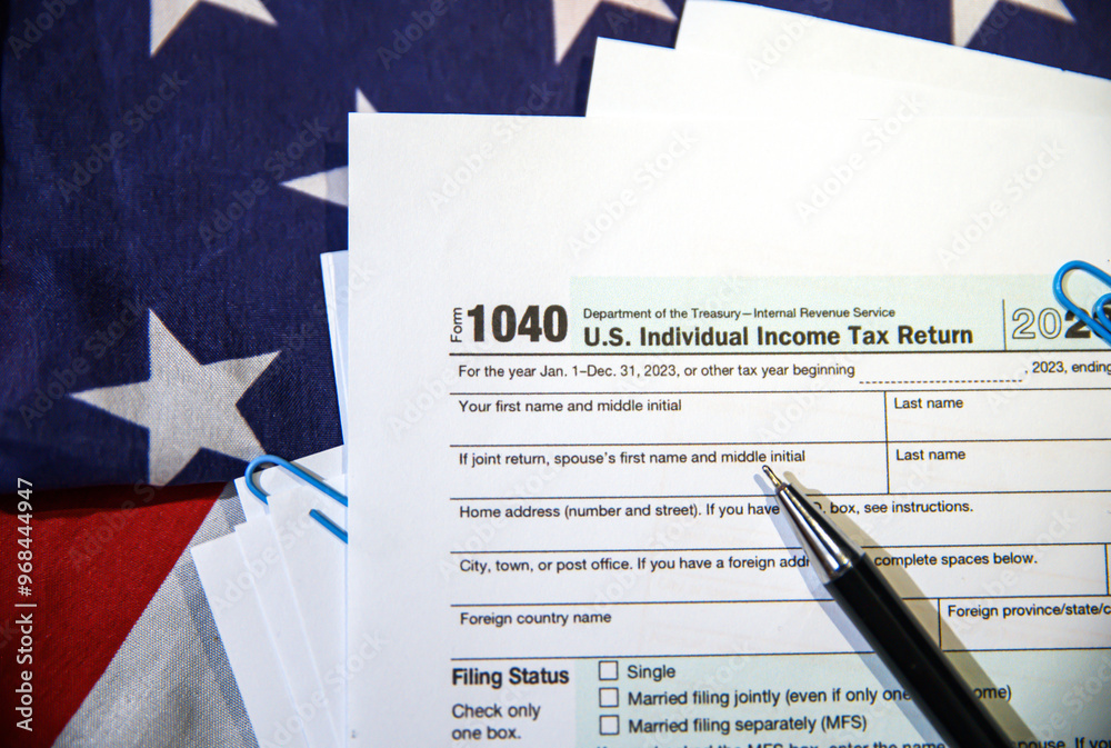 1040 U.S. Income Tax Return form with Pen and American flag in the ...
