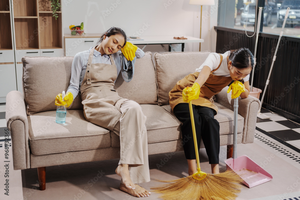 Two women contractors working as housekeepers in an office, wiping ...