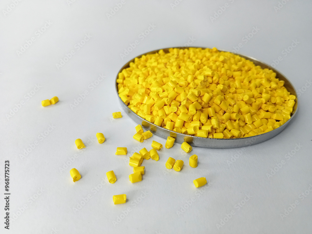 Yellow masterbatch granule, yellow polymer granules in a cup, cold ...