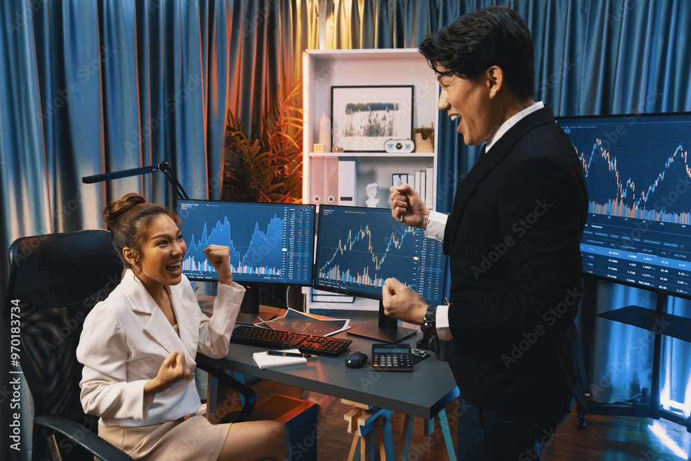 Successful business traders raising fist up with highest profit looking ...