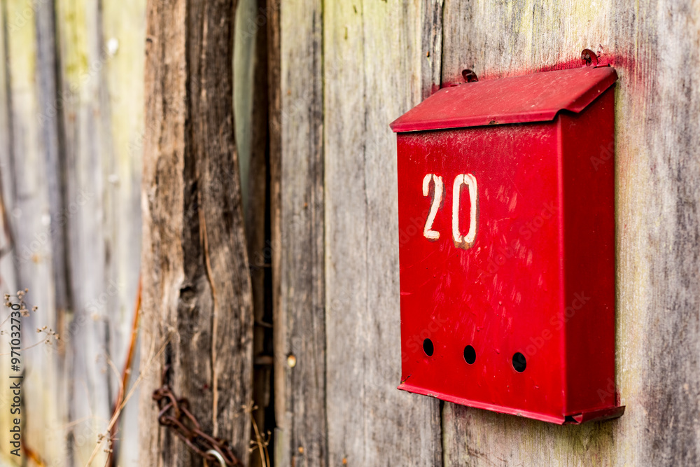 Red letterbox, mailbox number 20, twenty. Autumn perspective, details ...