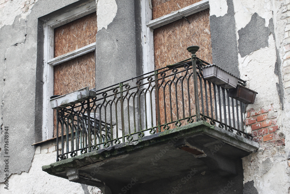 Tenement building balcony. Brick wall cracked facade. Old architecture ...