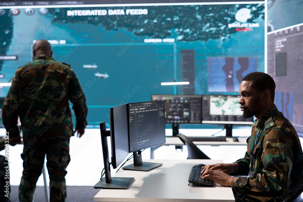 Military crew in a high tech operations command post managing ...