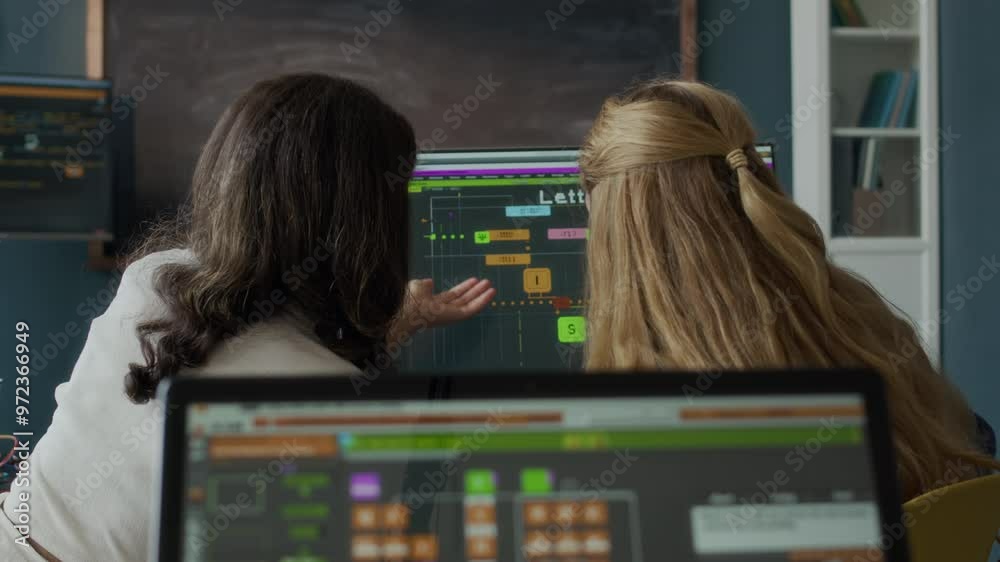 Back view waist up shot of two multiethnic gen z female students ...