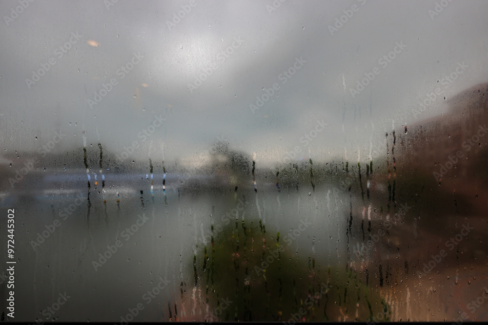 Water condensation drop dripping on hot humid rainy day fogging window ...