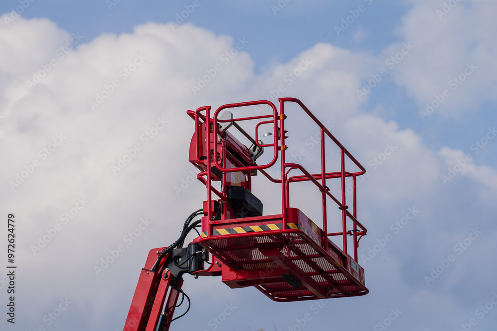 Red construction lift platform raised in the air without any person ...