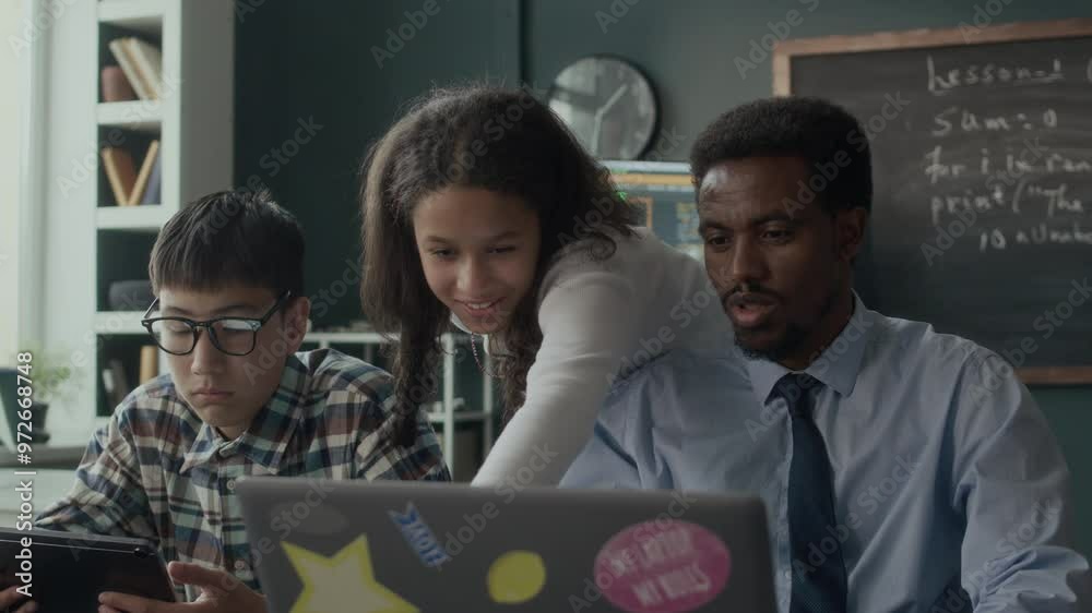 Medium shot of young Black male teacher and diverse gen z students ...