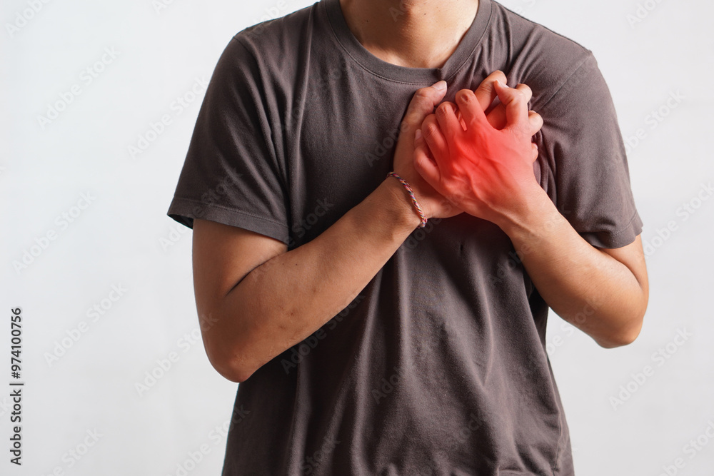 man suffering from central chest pain. Chest pain can be caused by ...