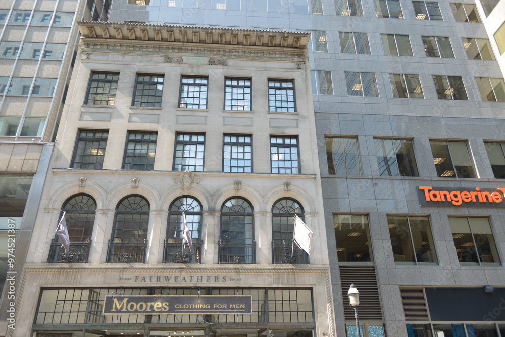 Foto de historic building facade with sign of Moores Clothing for Men ...