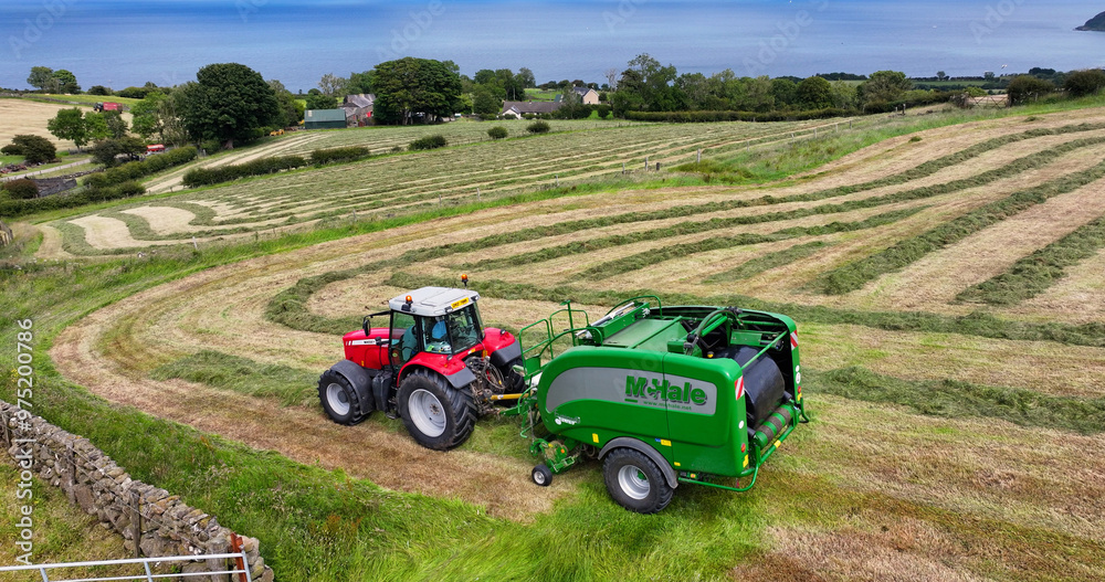 Aerial View of a Massey Ferguson 6480 tractor Baling silage with a ...