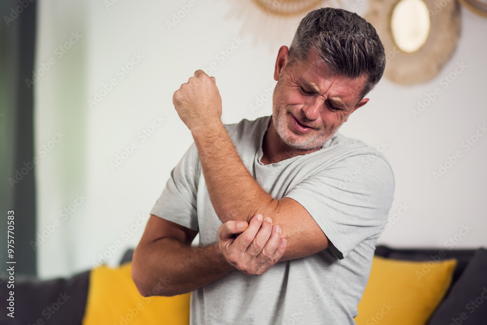 Man With Pain In Elbow. Pain relief concept. Middle age man feeling the ...