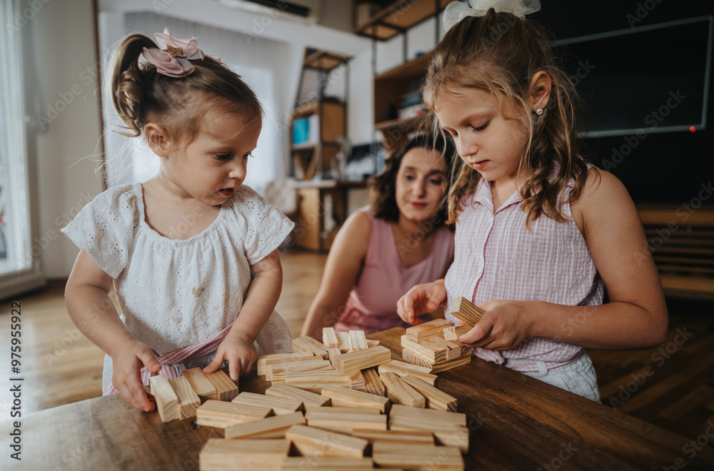 Two young sisters spend family time indoors, engaging in a fun and ...