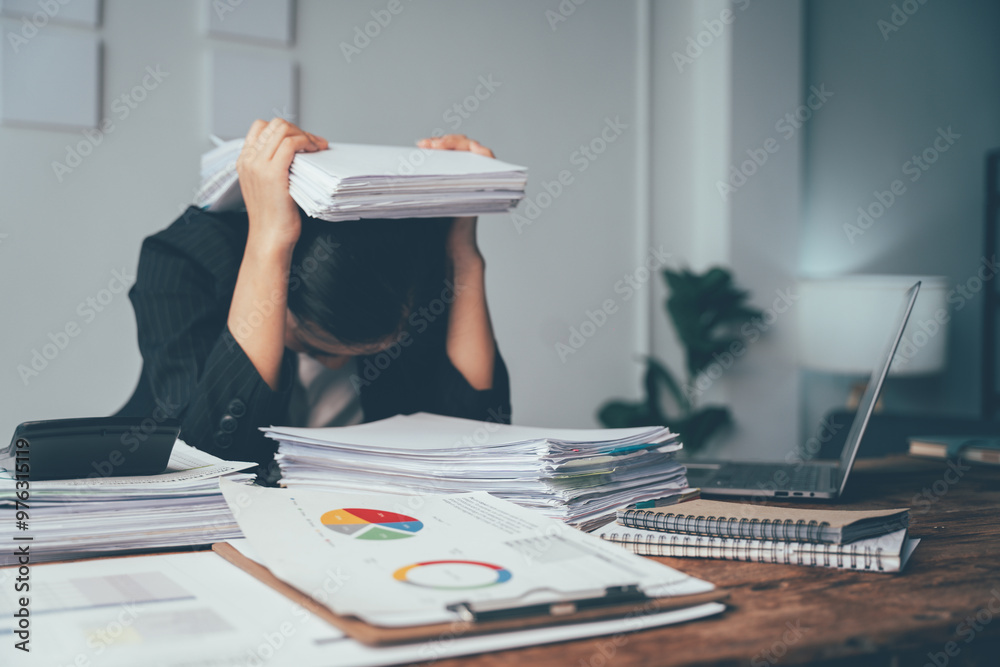 Overwhelmed and Defeated: A businesswoman burdened by paperwork in a ...