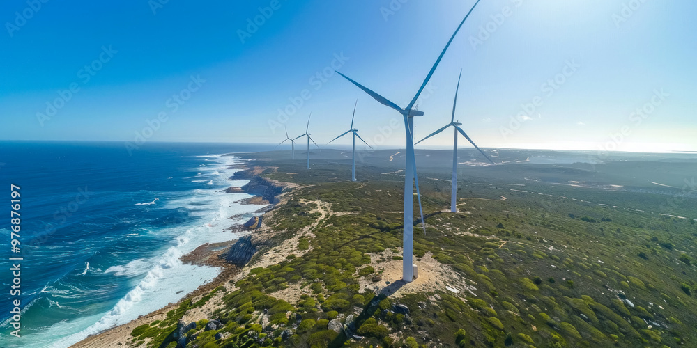 Coastal wind farm with turbines lined along a cliff, overlooking the ...