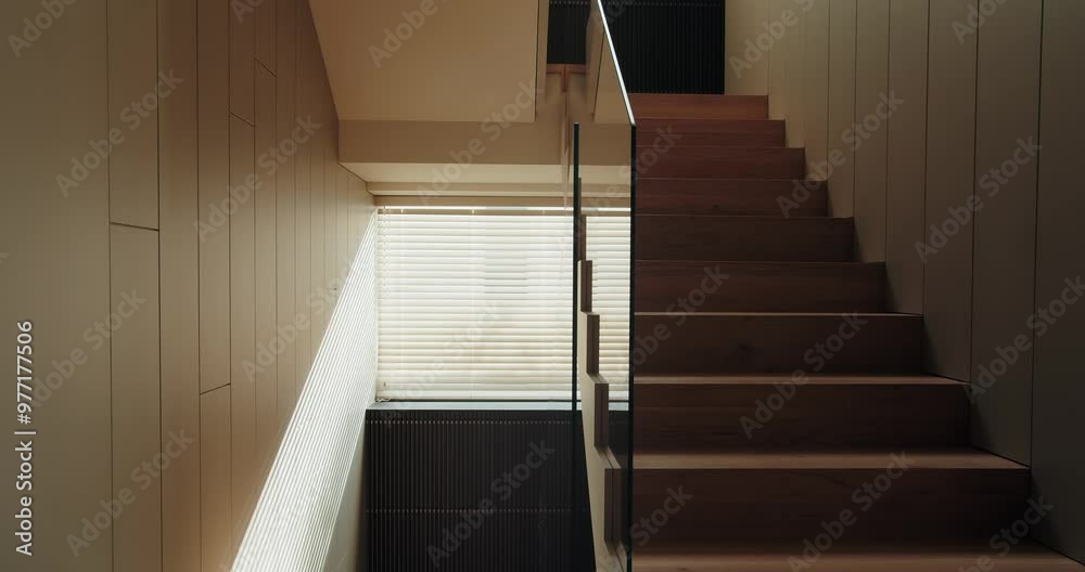 A sleek, modern home featuring a wooden staircase with ambient lighting ...