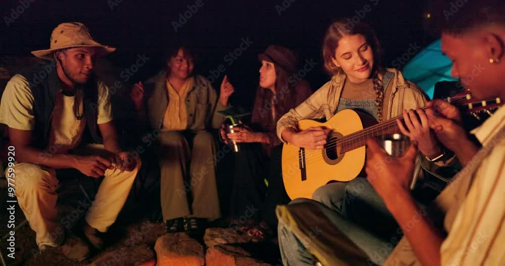 Camping, guitar and friends singing at night together for adventure ...