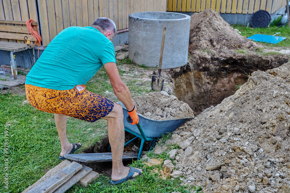 When digging pit for septic tank made of concrete rings, homeowner uses ...