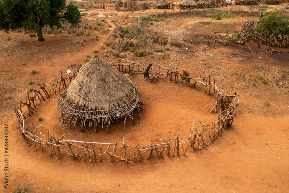 Aerial view of a rural village with traditional huts and thatched roofs ...